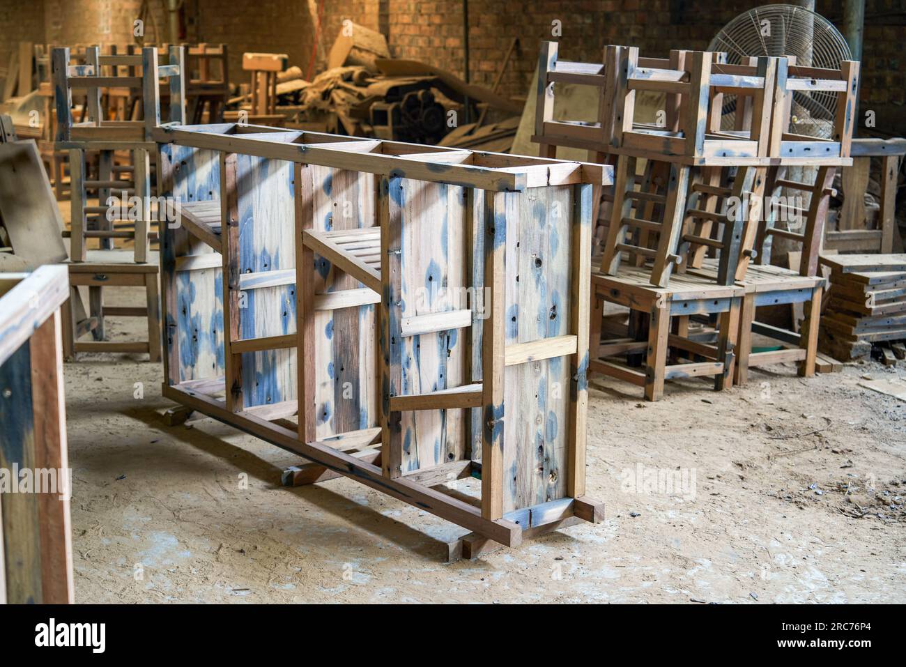 A busy and messy furniture processing factory Stock Photo - Alamy