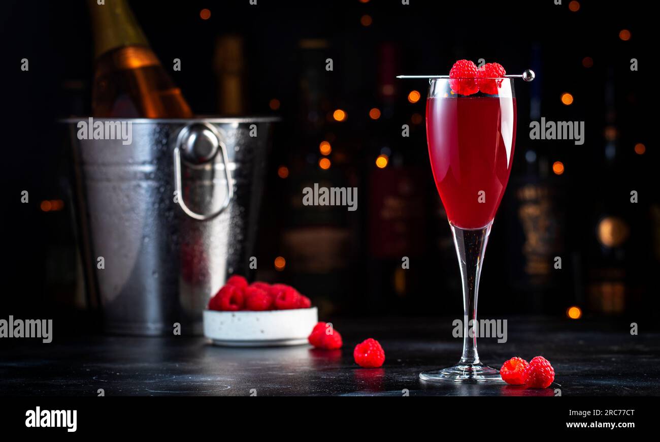 Moulin rouge alcoholic cocktail drink with calvados, prosecco, lychee and raspberry peach puree ...