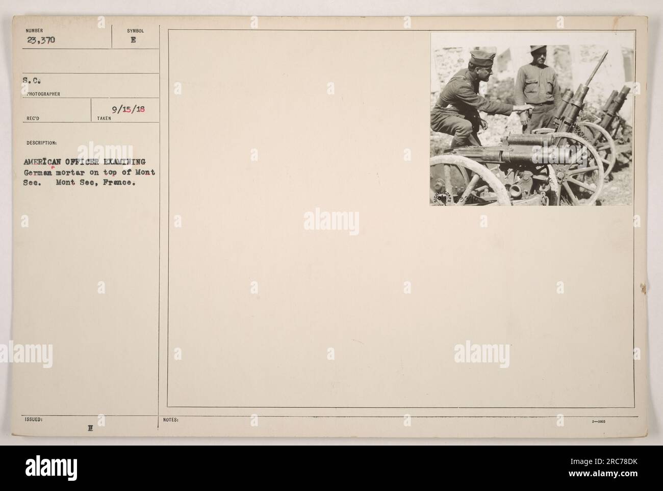American officer examining a German mortar on top of Mont See in Mont ...