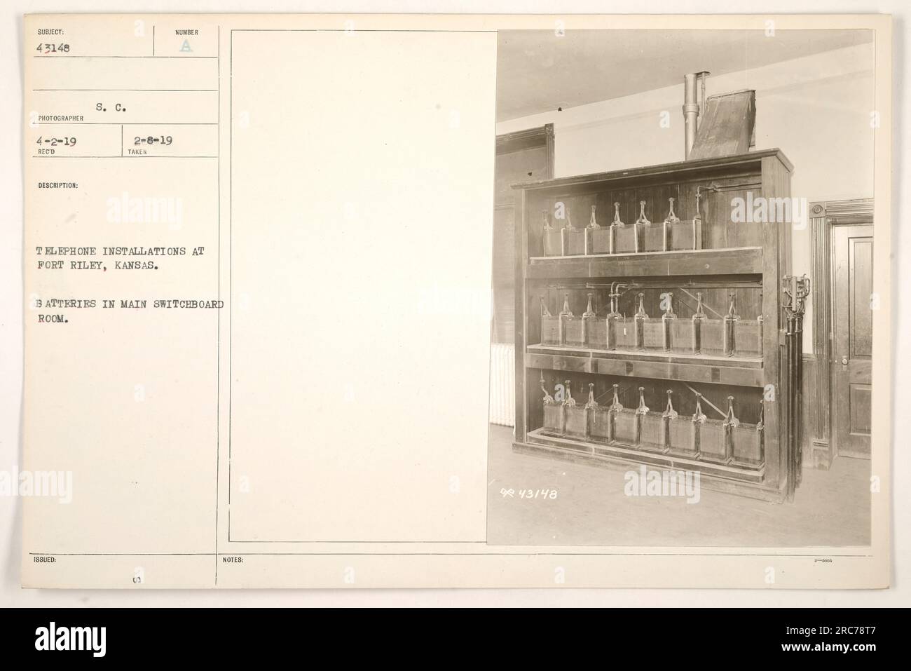 The photograph depicts batteries in the main switchboard room of ...