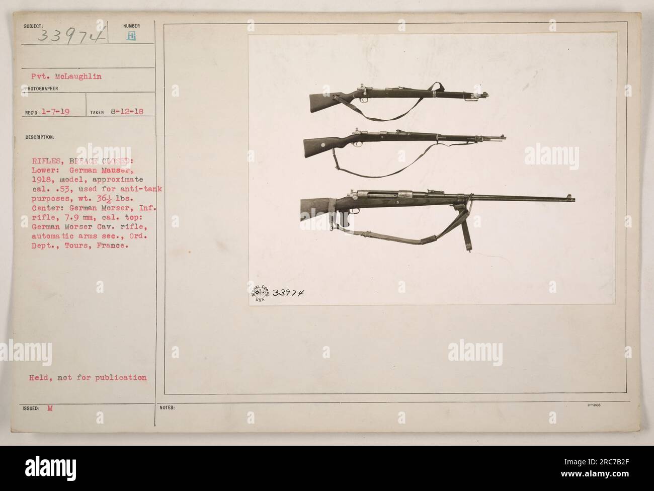 Private McLaughlin is photographed holding three different German ...
