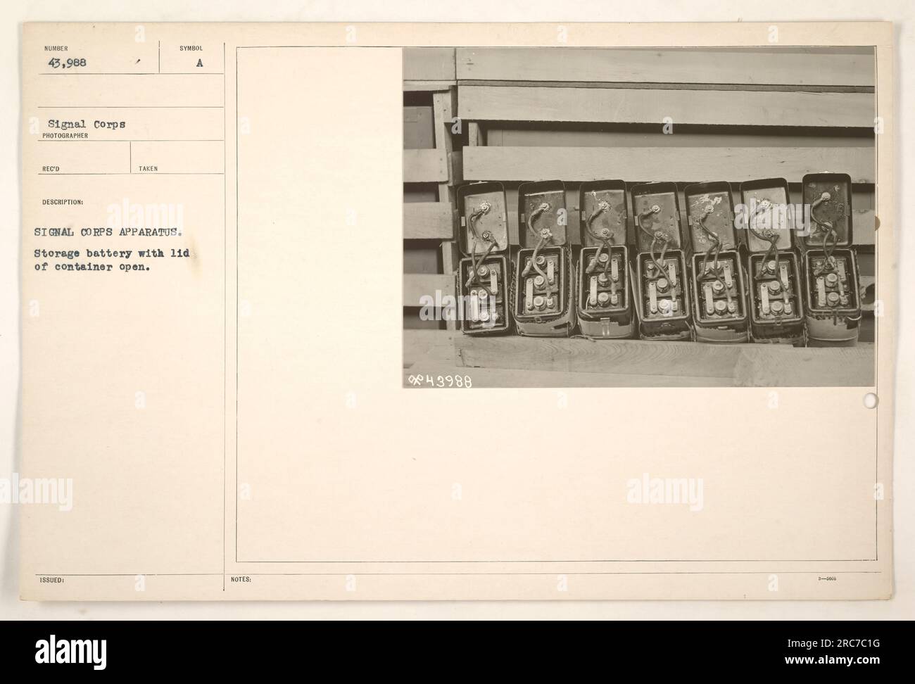 A photograph depicting a storage battery with the lid of its container ...