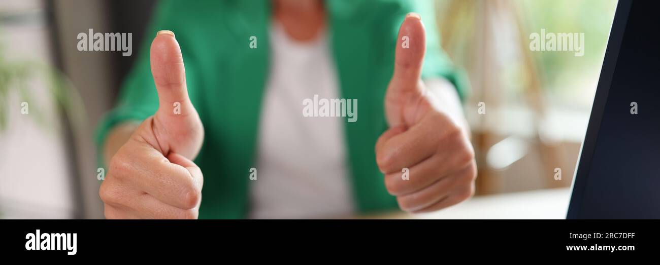 Business woman with thumbs up in office and table with computer and ...