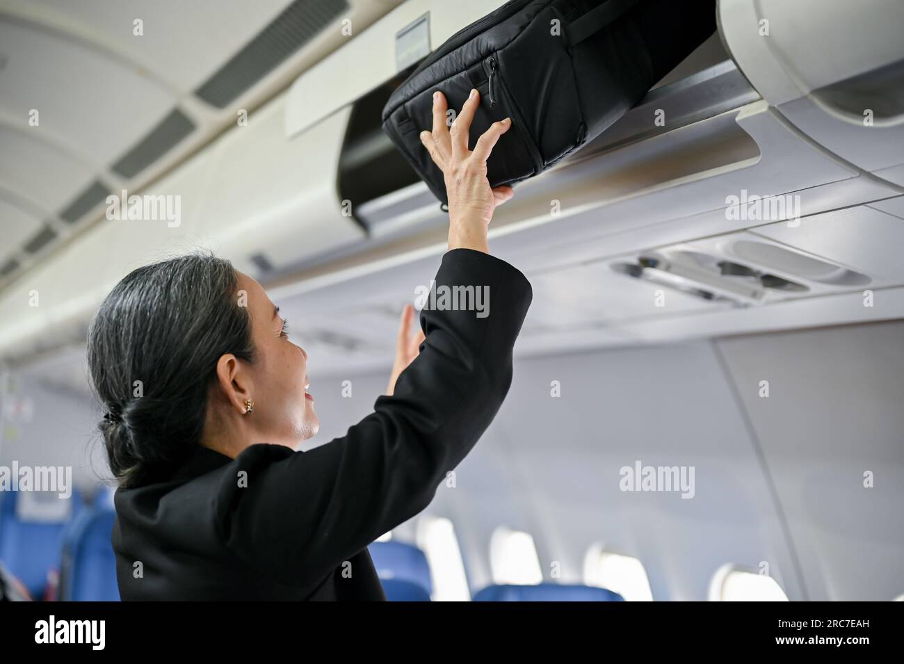 Overhead locker airplane hi-res stock photography and images - Alamy