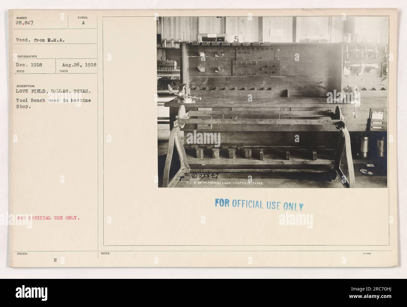 Soldiers working on a tool bench in a machine shop at Love Field ...
