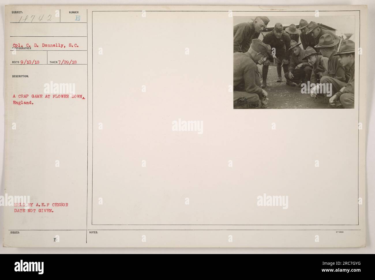 Caption: "Cpl. C. D. Donnelly, S. C. participating in a crap game at ...