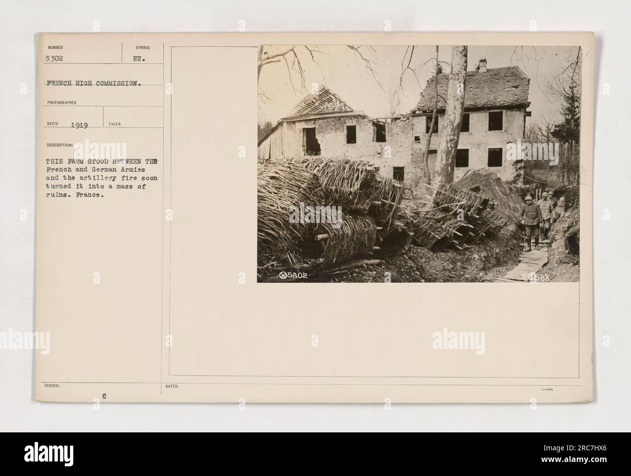 Soldiers stand amongst the ruins of a farm destroyed by artillery fire ...