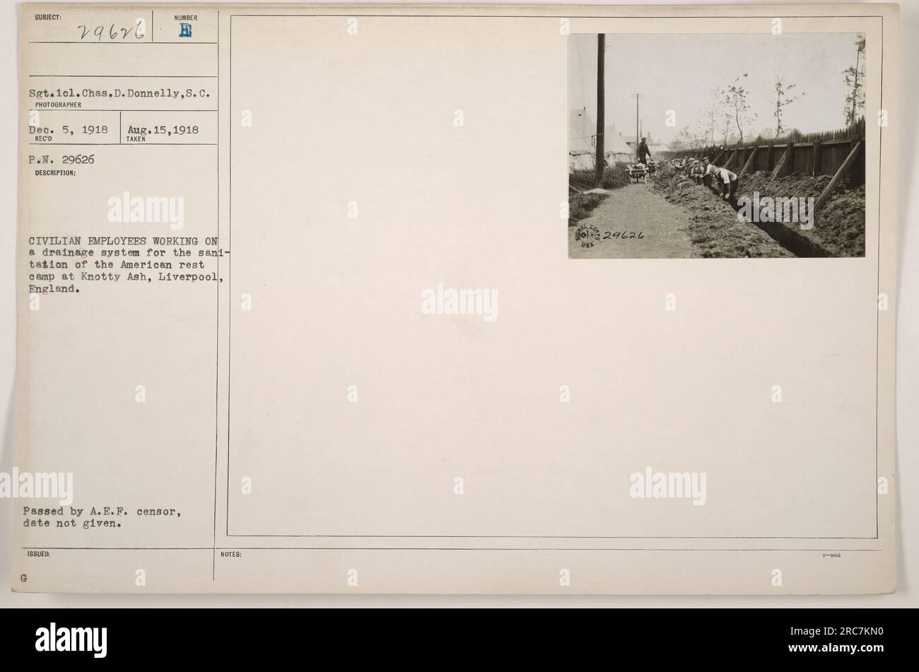 Civilian employees are seen working on a drainage system for the ...