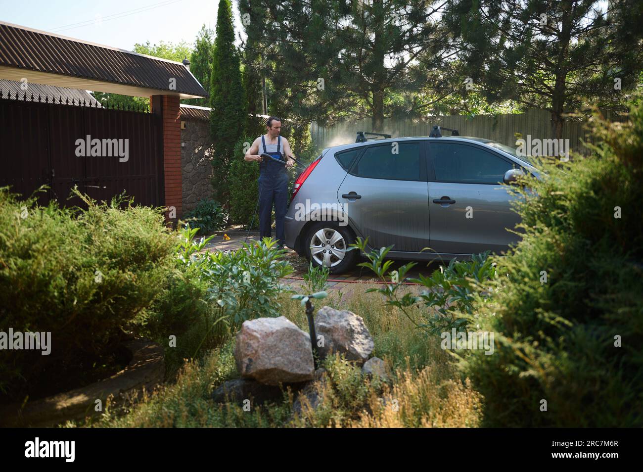 Man washing car using jet spray hi-res stock photography and images - Alamy