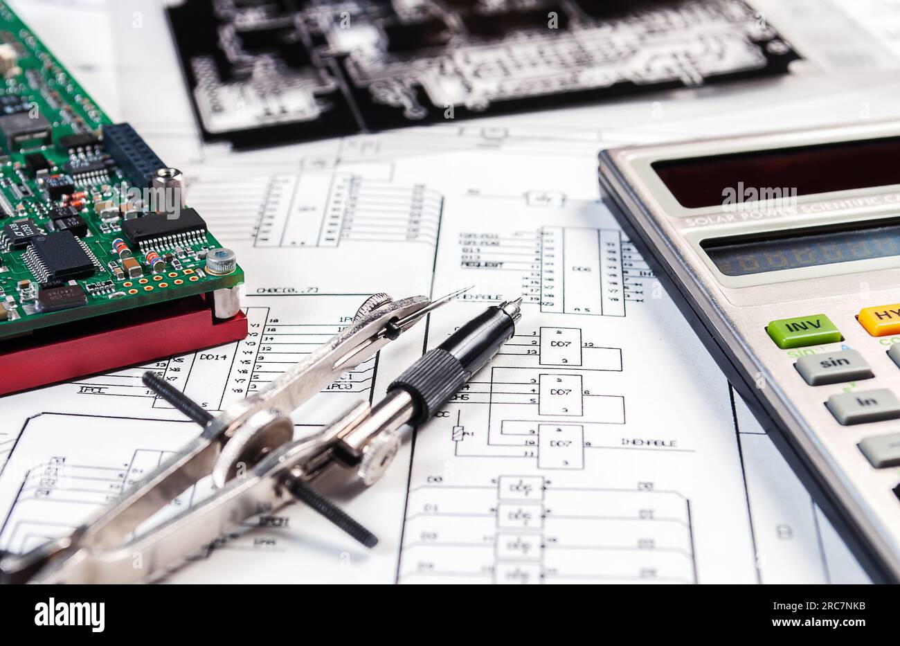 Electronic board, calculator, tweezers and photomask on background of ...
