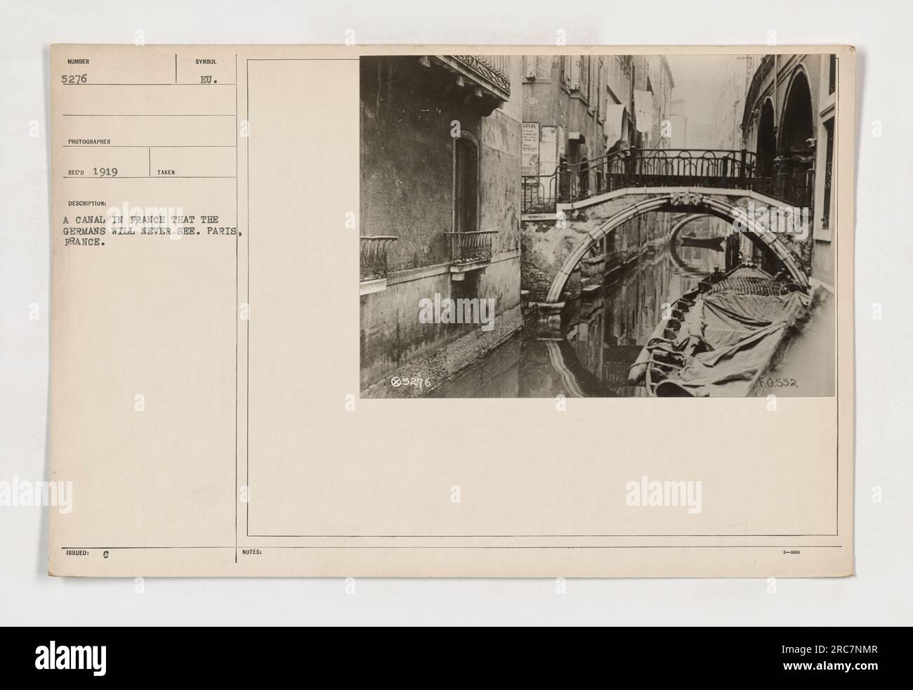 A photograph shows a canal located in France, taken in 1919. The image ...