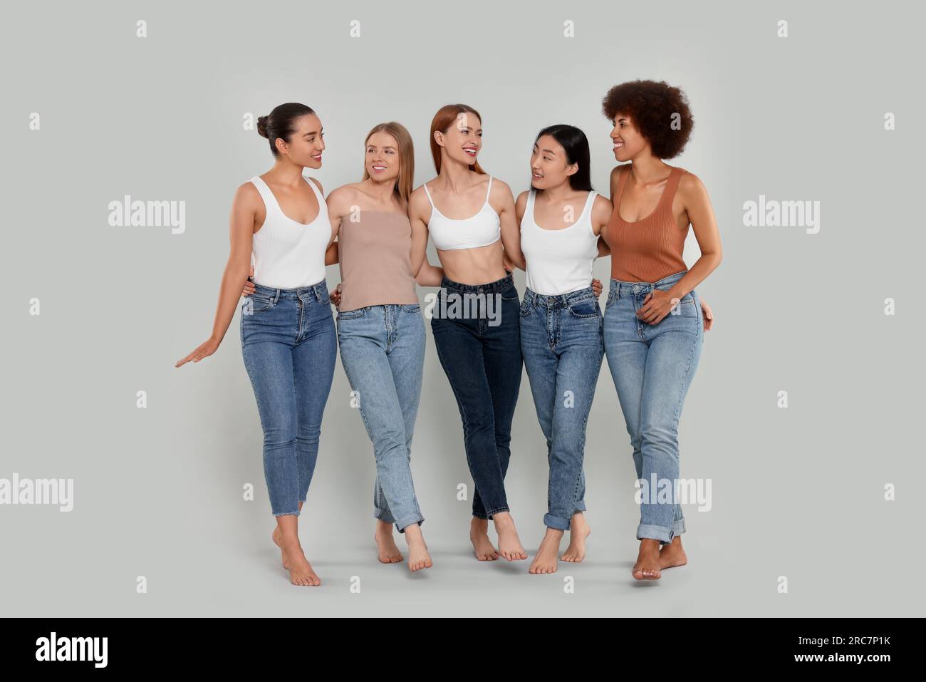 Group of beautiful young women on light grey background Stock Photo - Alamy