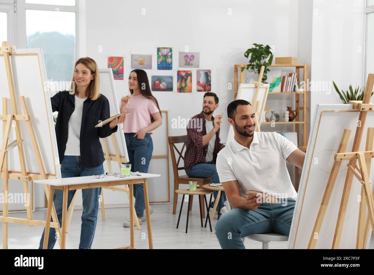 Group of students attending painting class in studio. Creative hobby ...