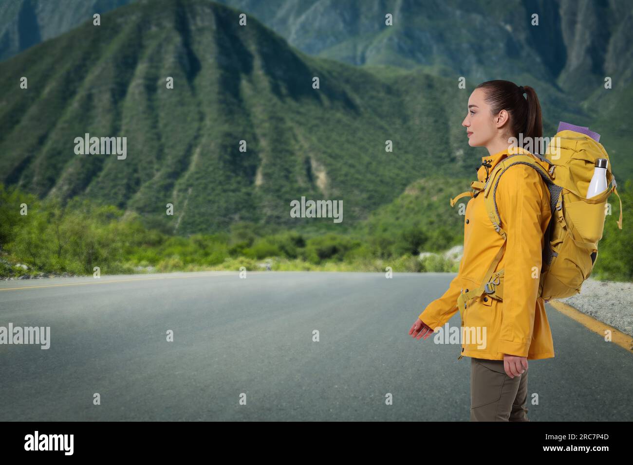Tourist with backpack on road near mountains Stock Photo - Alamy