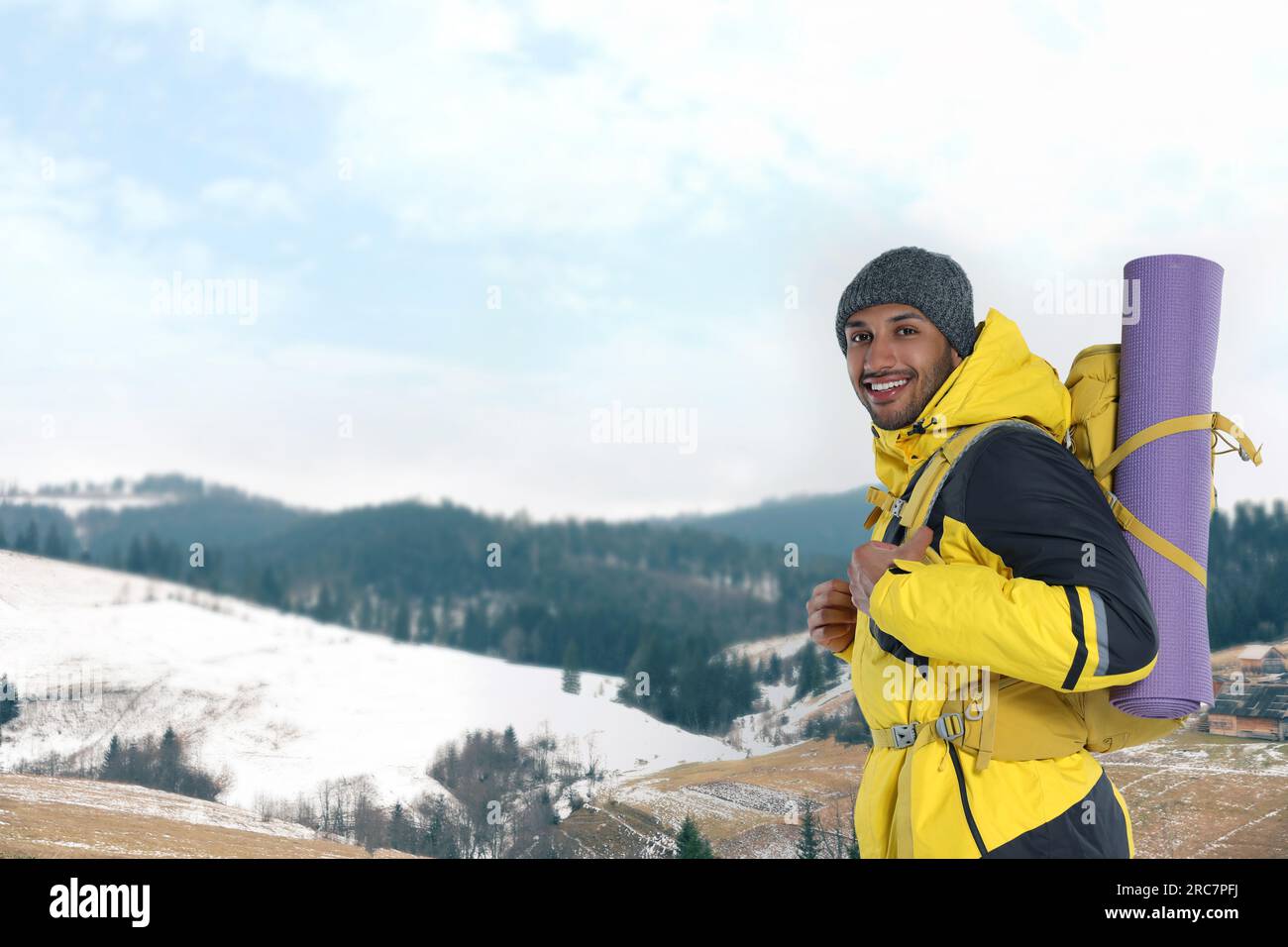 Happy tourist with backpack in snowy mountains Stock Photo - Alamy