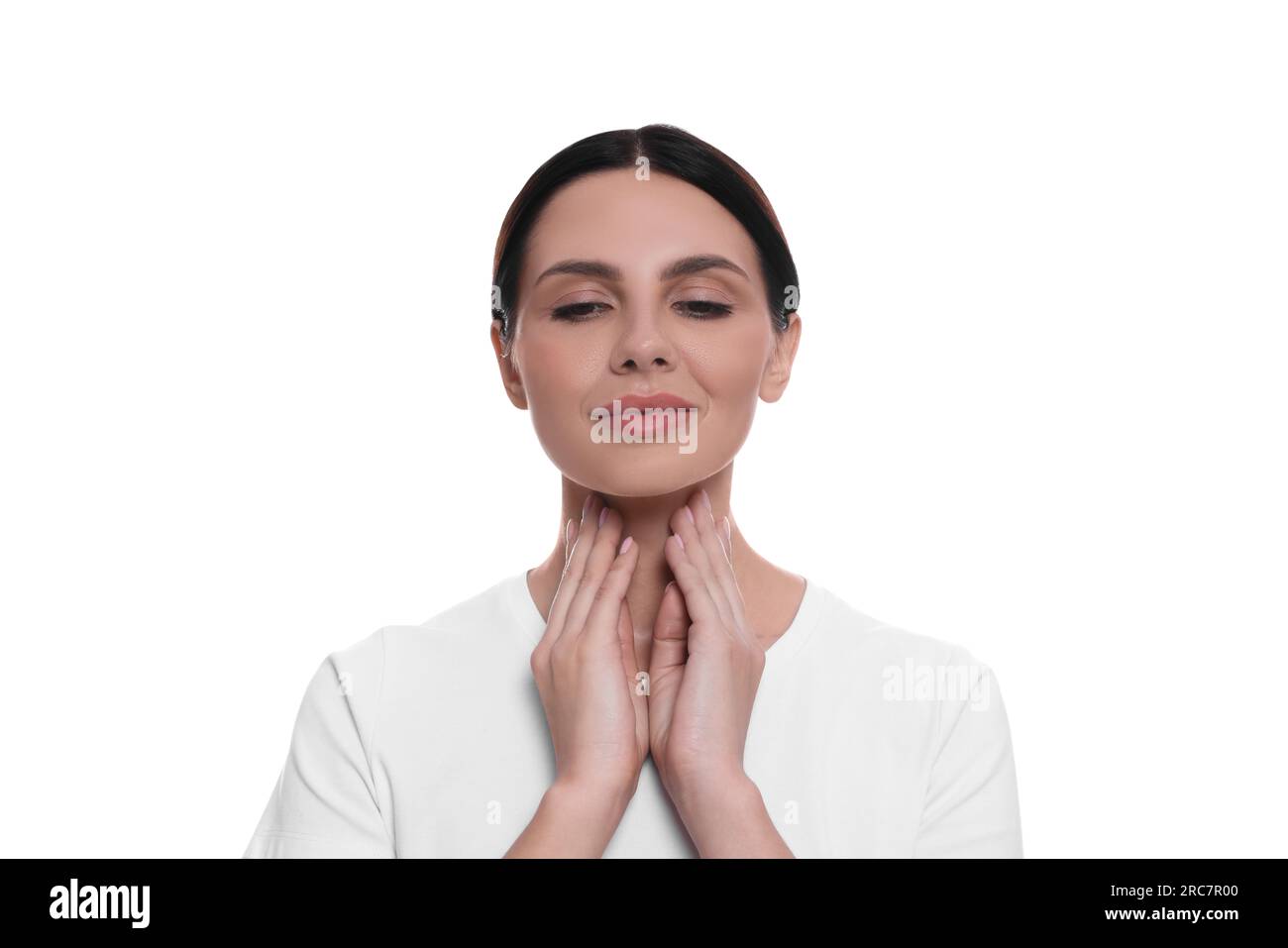 Endocrine system. Young woman doing thyroid self examination on white ...