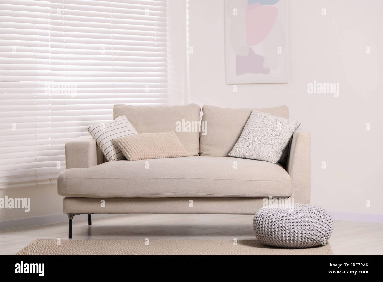 Stylish soft sofa with cushions in living room. Interior design Stock ...