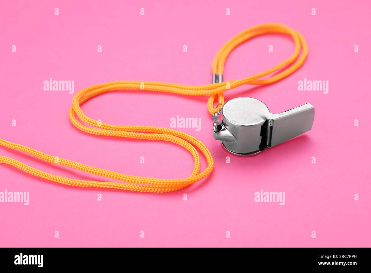 One metal whistle with cord on pink background Stock Photo - Alamy