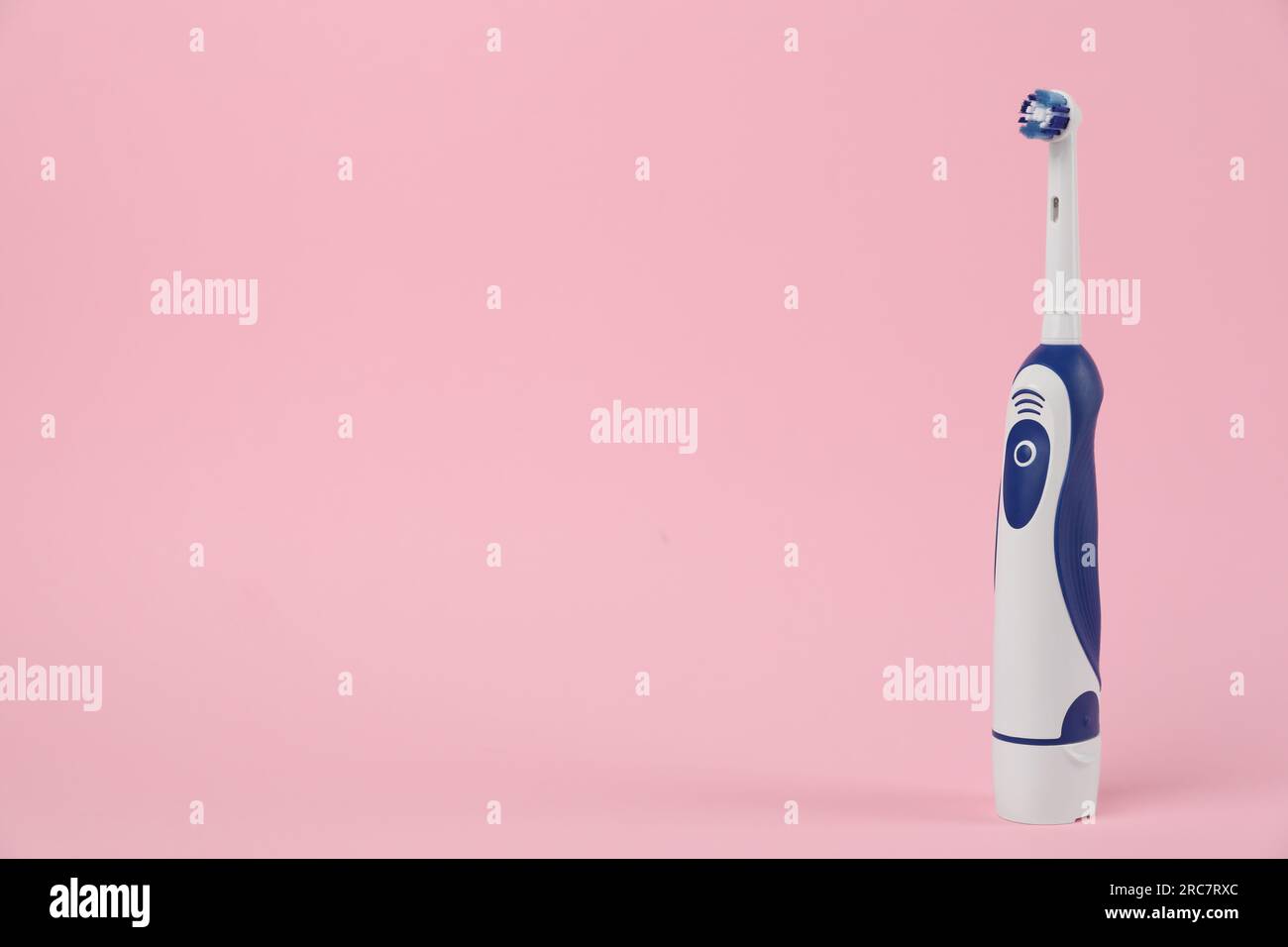 Electric toothbrush on pink background, space for text Stock Photo - Alamy