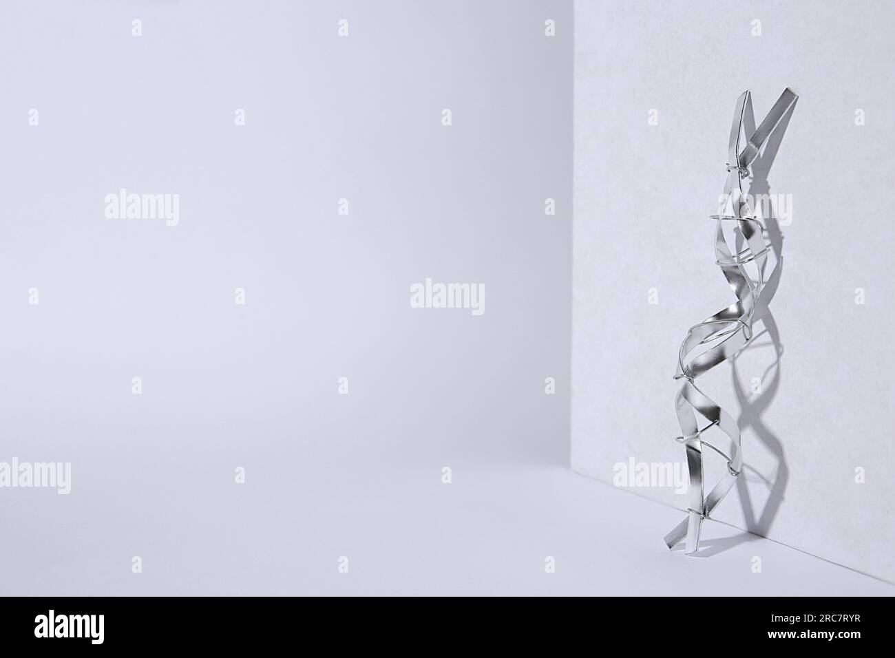 DNA molecular chain model made of metal on white background, space for ...