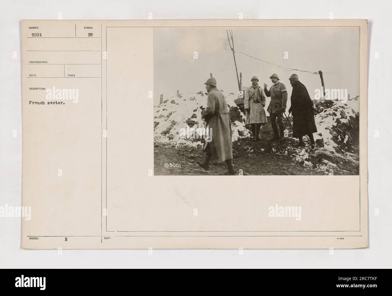 Soldiers carrying equipment and rifles through trenches in the French ...