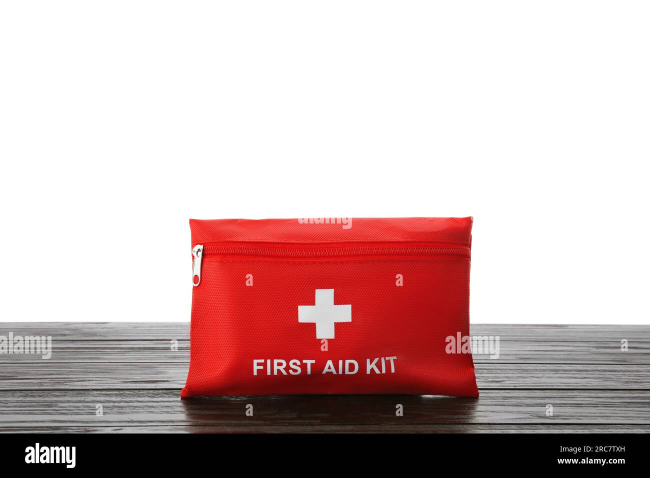 First aid kit on wooden table against white background Stock Photo - Alamy