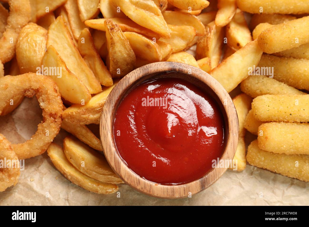Different snacks and tasty ketchup on table, flat lay Stock Photo - Alamy