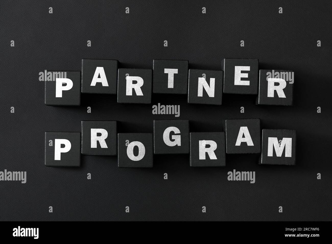 Words Partner Program made of cubes with letters on black background ...