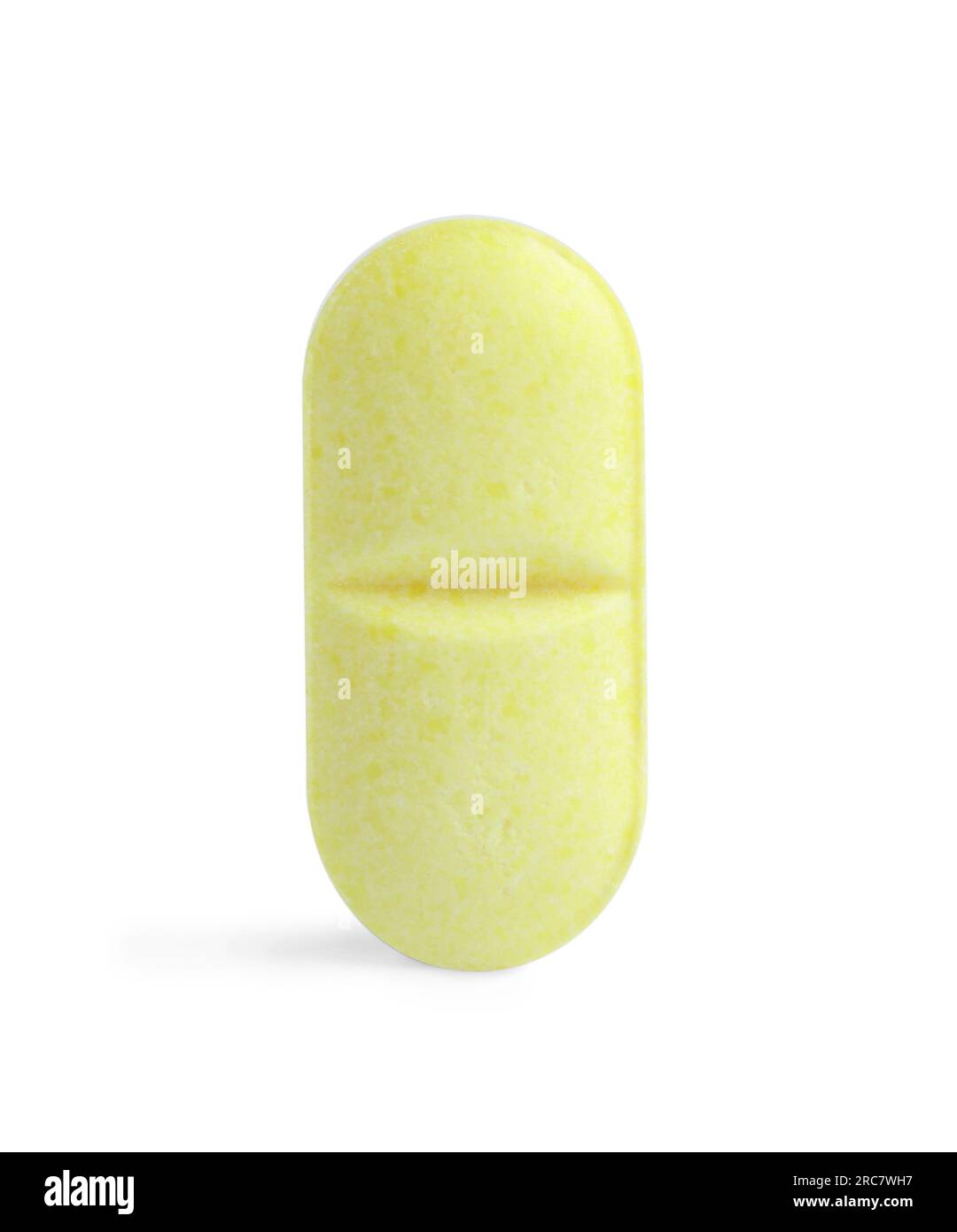 One yellow pill isolated on white. Medicinal treatment Stock Photo - Alamy