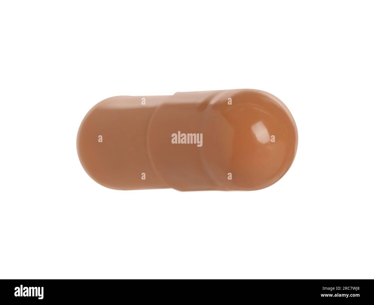 One brown pill on white background. Medicinal treatment Stock Photo - Alamy