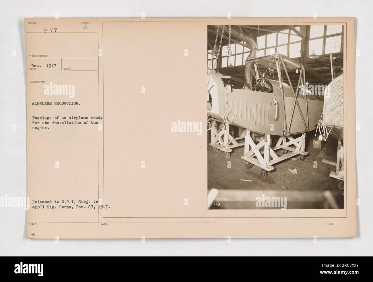 The photograph shows an airplane fuselage that is being prepared for ...