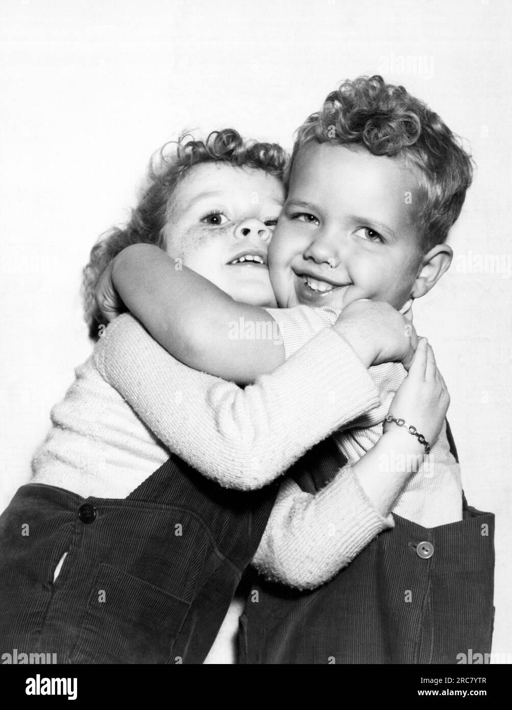 Los Angeles, California: c. 1946 A small boy gives his sister an ...