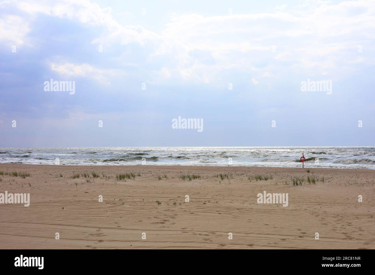 a sandy beach with a washed-out blue ocean and cloudy sky. Storm Stock ...