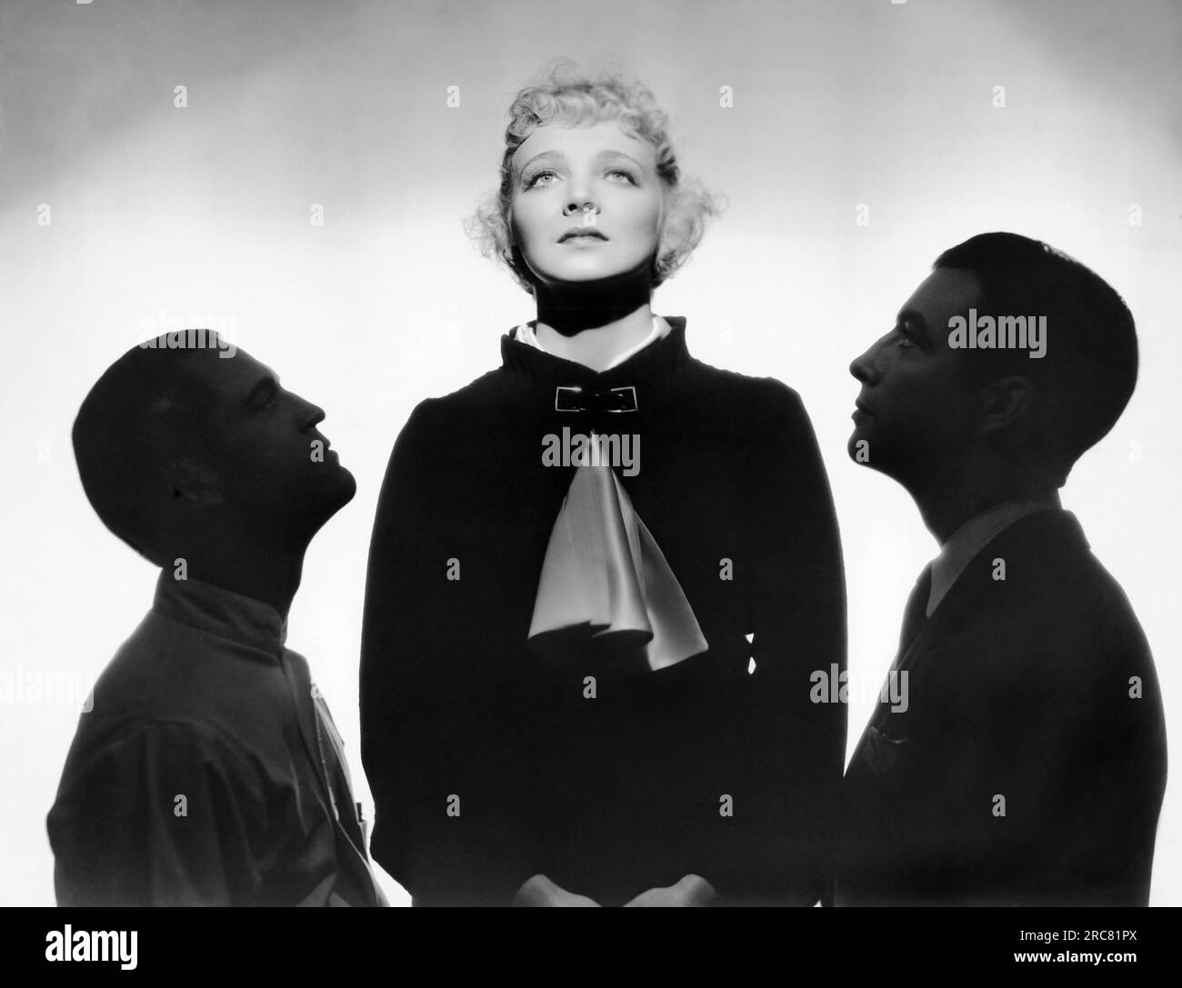 Hollywood, California: c. 1945 Two men gaze up at a woman standing ...