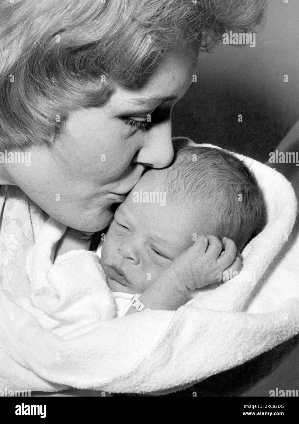 United States: c. 1958 A mother gives her new born baby a kiss Stock ...