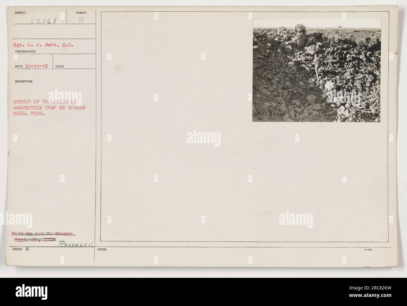 Soldier surveying the aftermath of an ammunition dump explosion caused ...