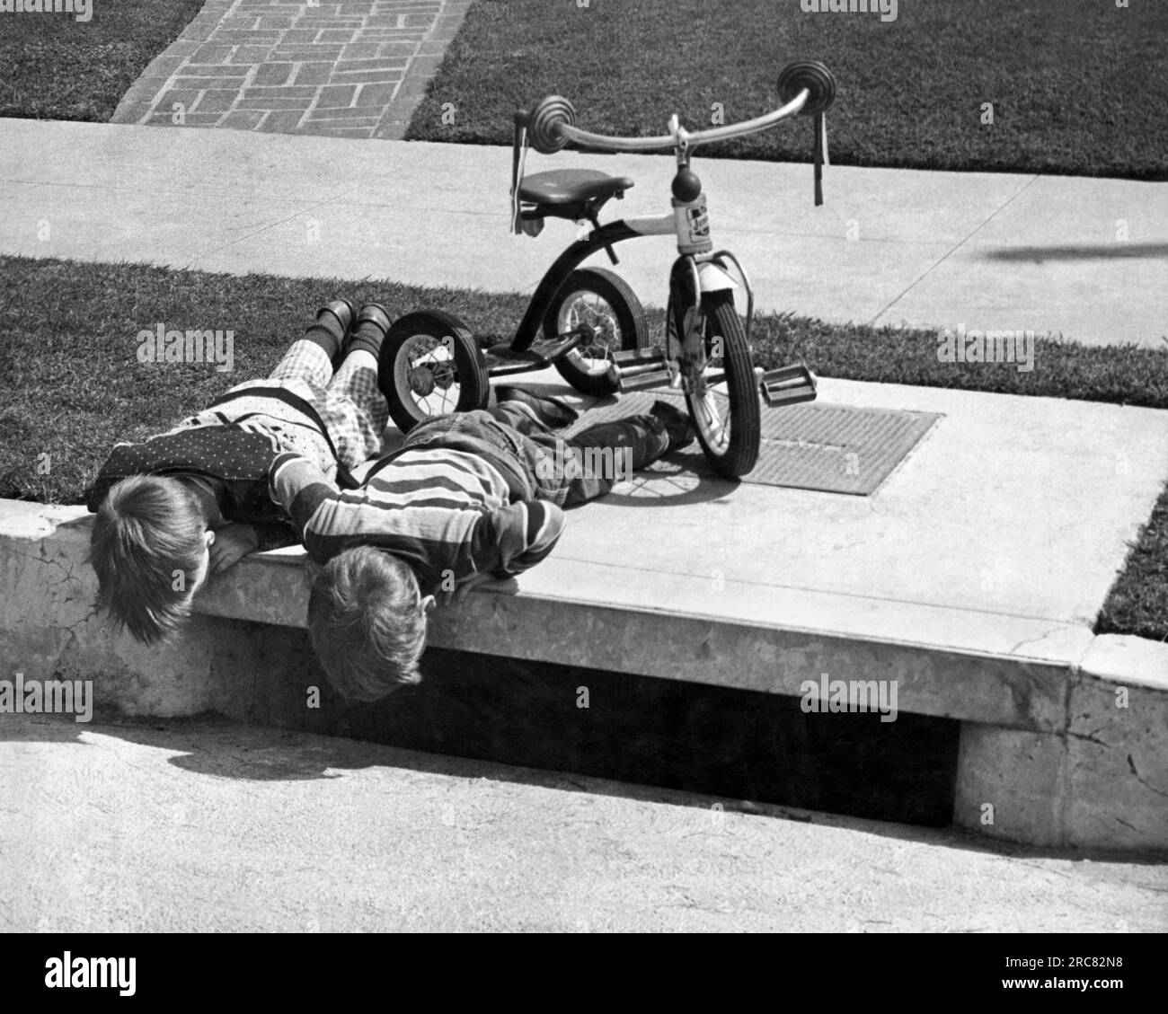 Long Beach, California: March 15, 1957. Two boys park their tricycle ...