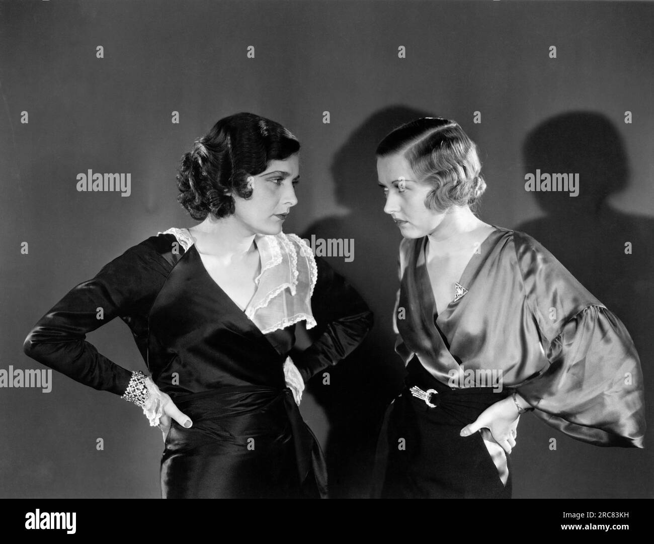 Hollywood, California: c. 1930. Two women staring angrily at each other ...