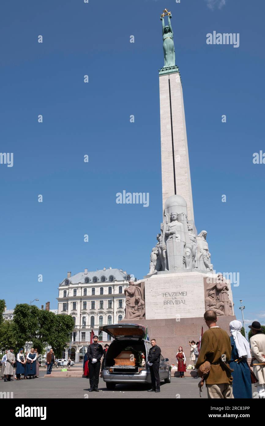 Commemoration with hearse at the Freedom Monument in Riga with people ...