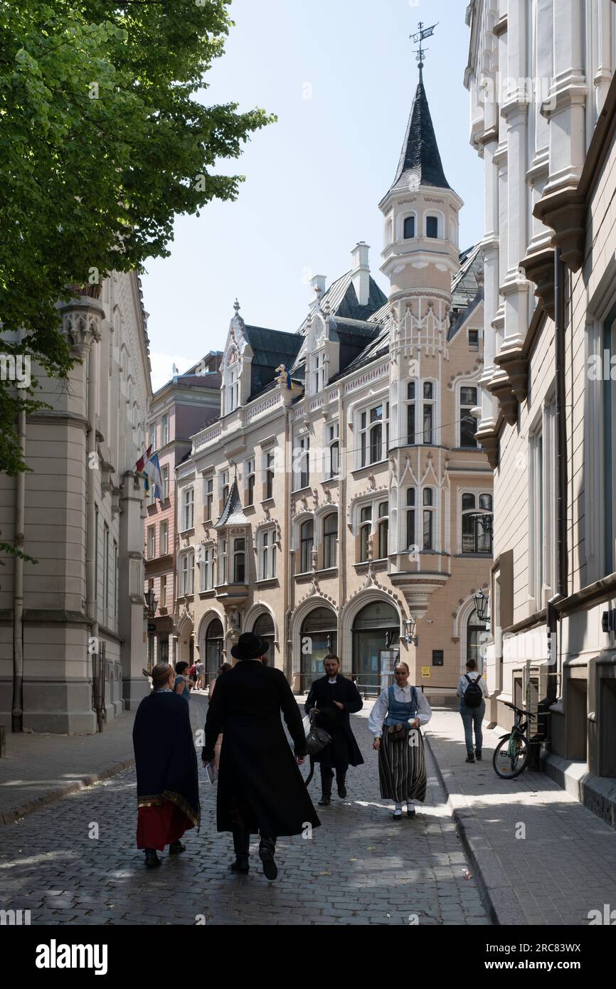 People in traditional Latvian costumes are walking in the Amatu iela ...