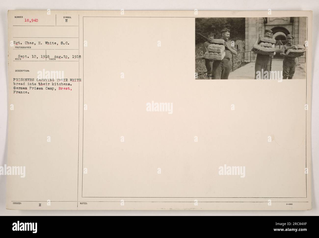 German prisoners carrying loaves of bread into their kitchen at the ...