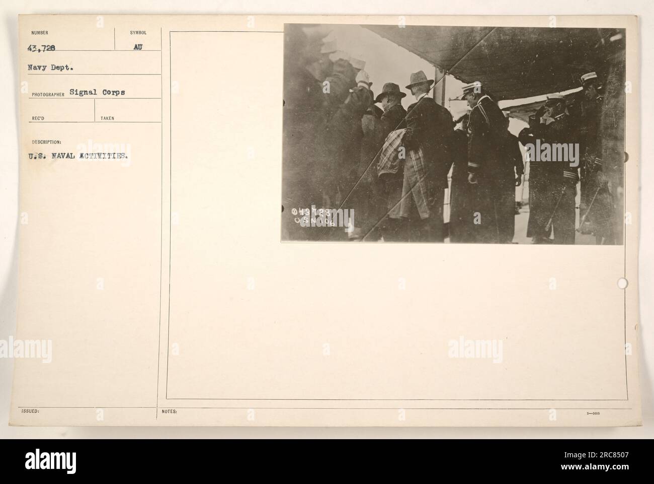 Naval personnel loading supplies onto a U.S. Navy ship during World War ...