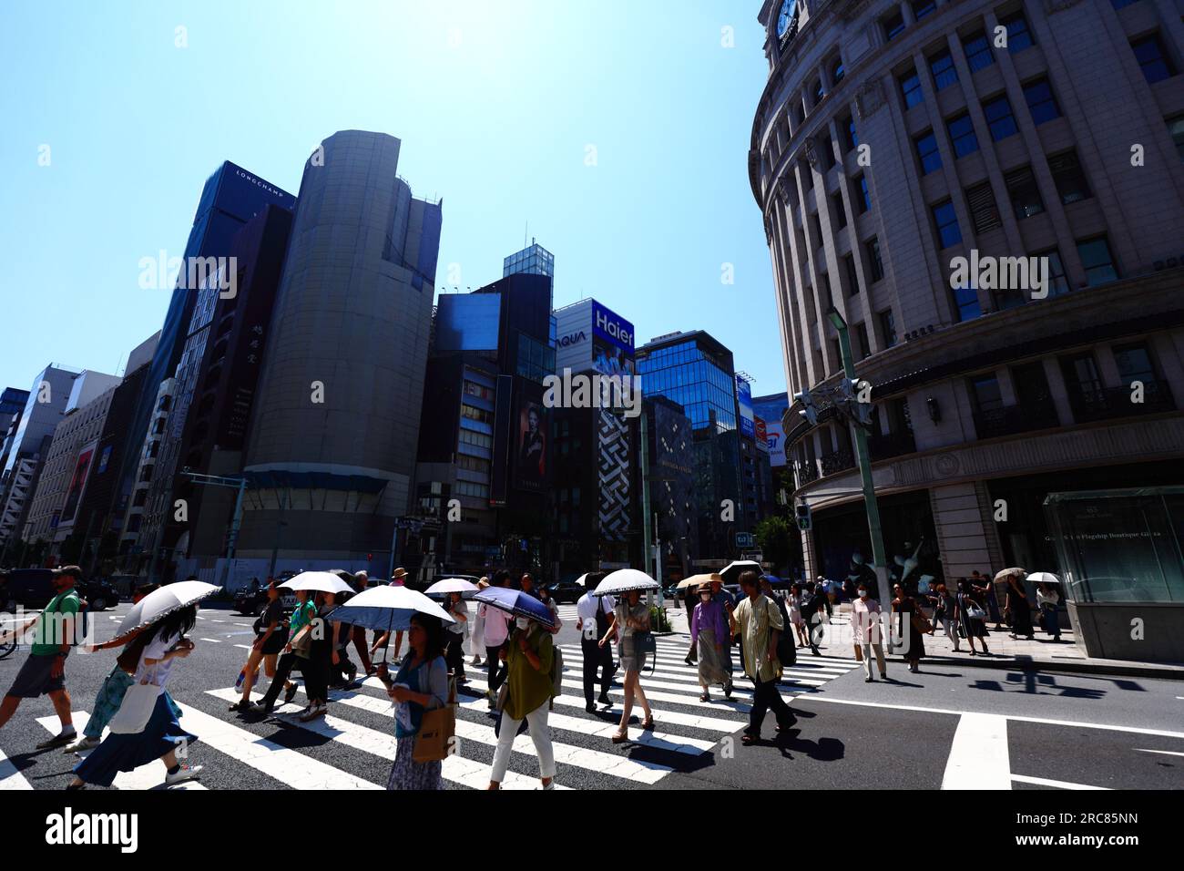 Tokyo, Japan. 12th July, 2023. Pedestrians walk with parasols in the ...