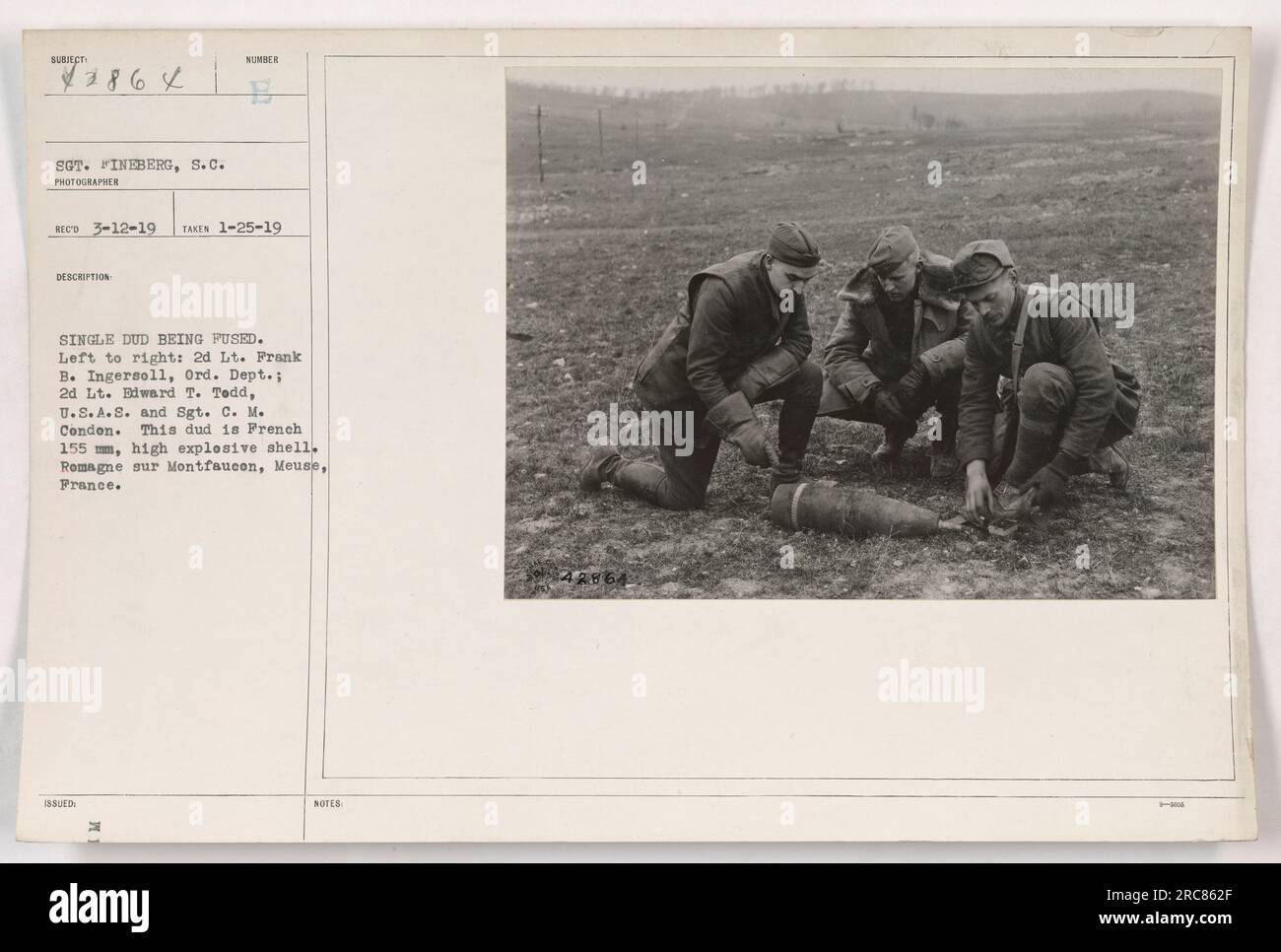 "American soldiers inspecting a single dud munition, a French 155mm ...