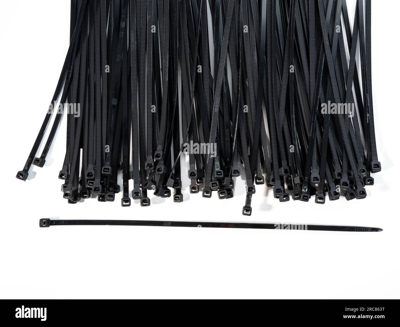 Plastic black ties on a white background. Plastic ties for cables Stock ...