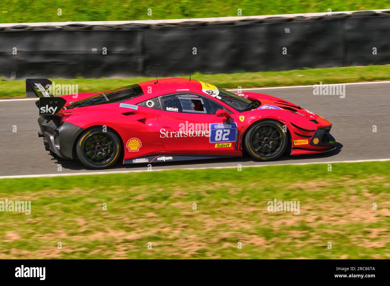 A red Ferrari Challenge race car during qualifying on a damp Oulton ...