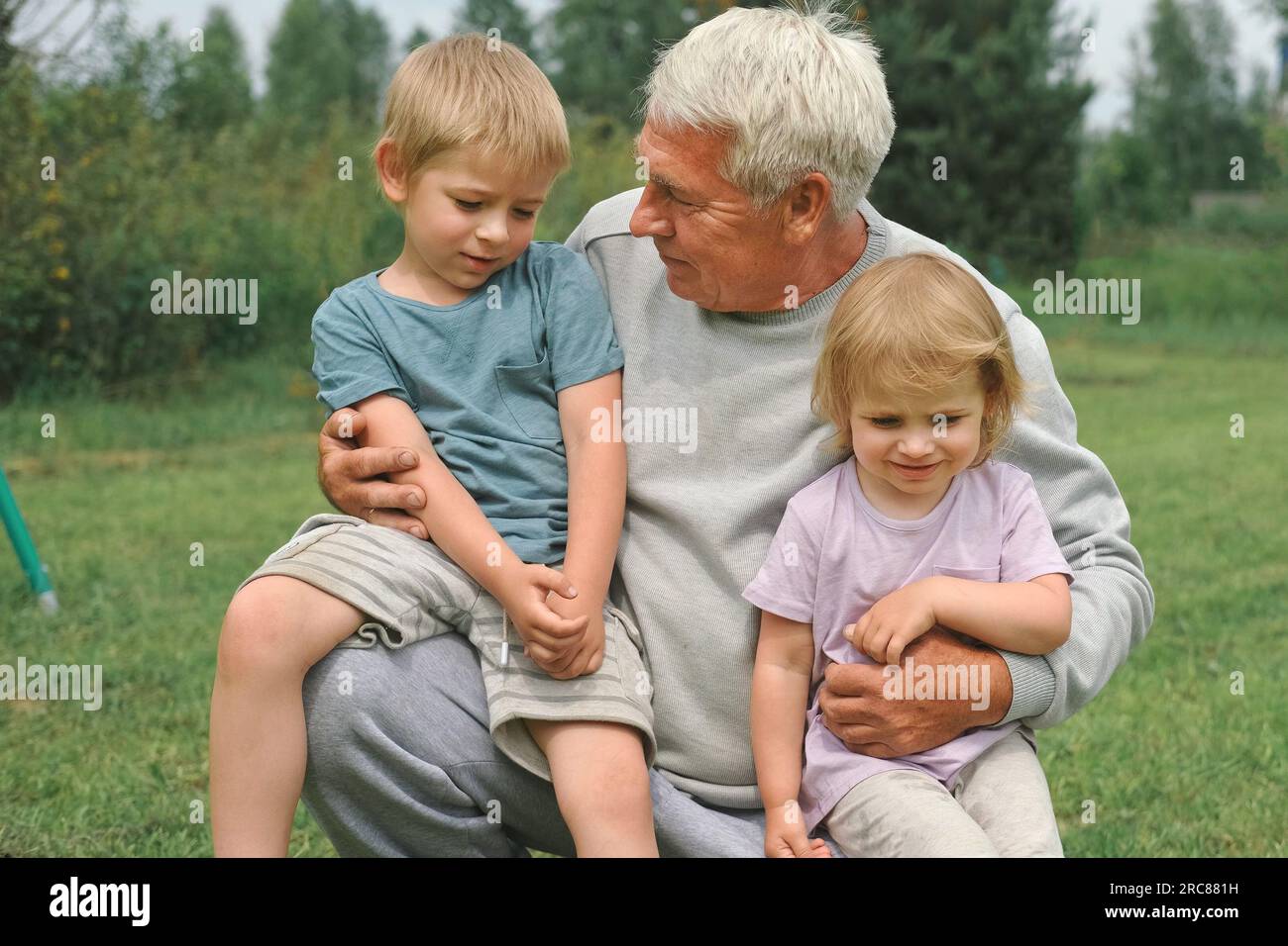 Grandfather and grandchildren have fun during walk In Park. Happy ...
