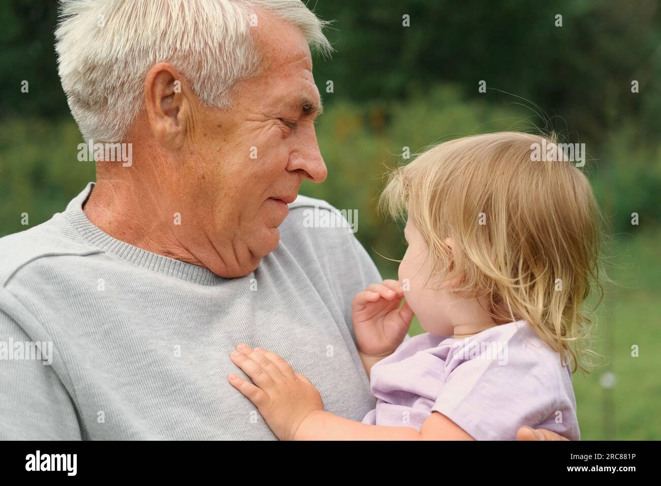 Grandfather and grandchild baby have fun during walk In Park. Happy ...