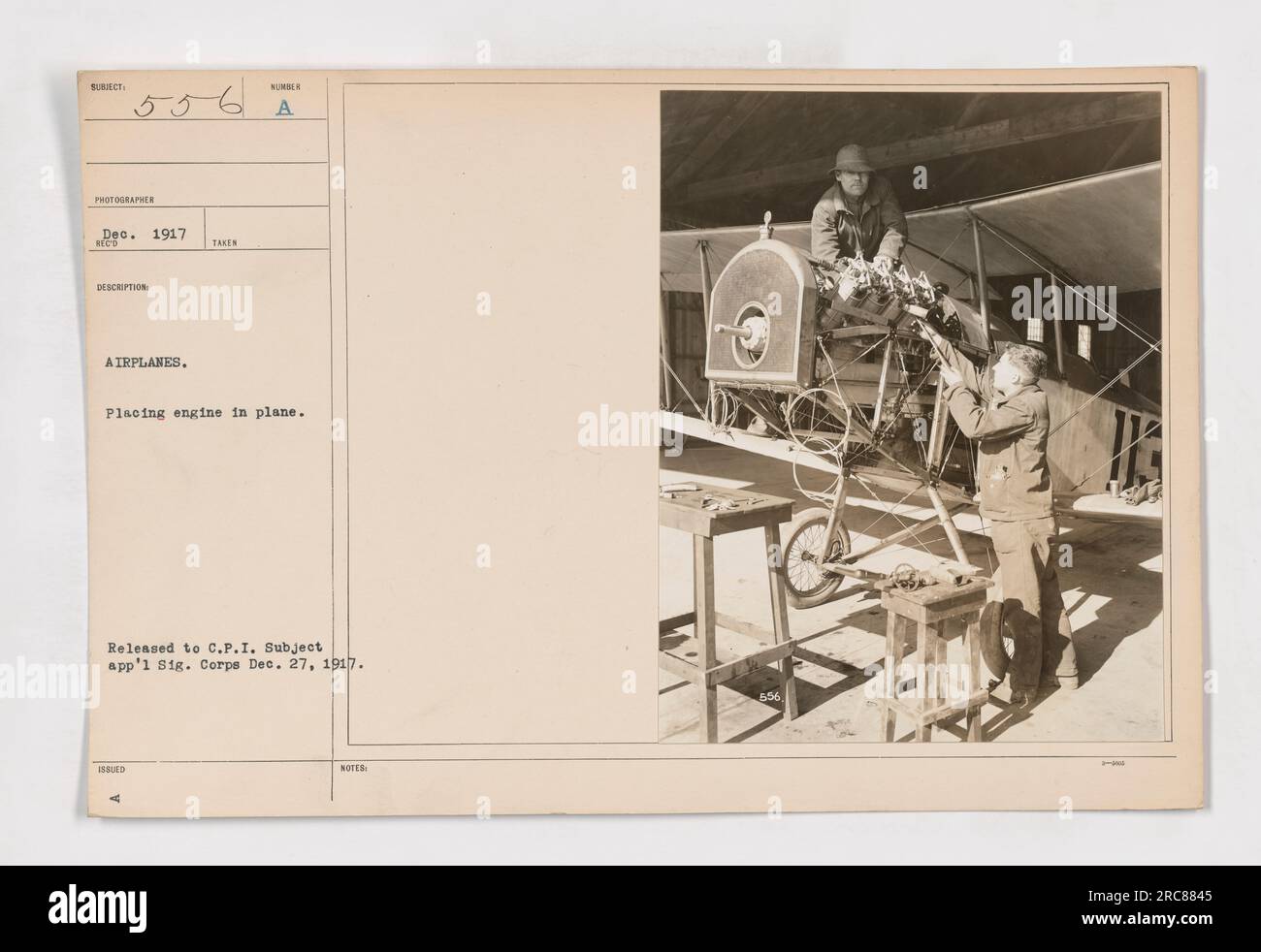 Airplane construction during World War One. In this photo, an engine is ...