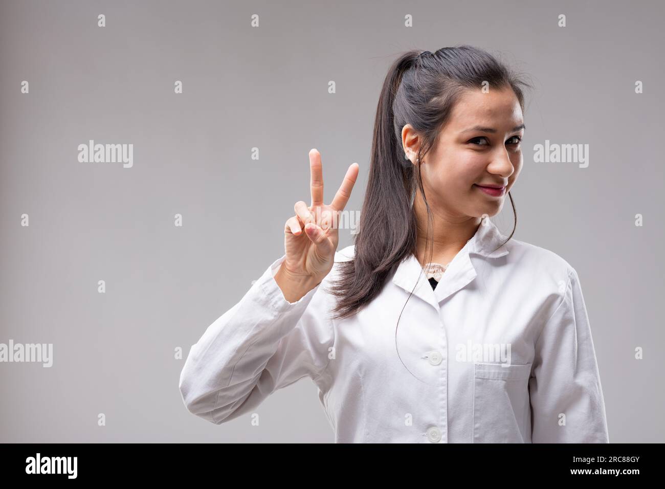 Victory is in sight for a young scientist, donning a white lab coat ...